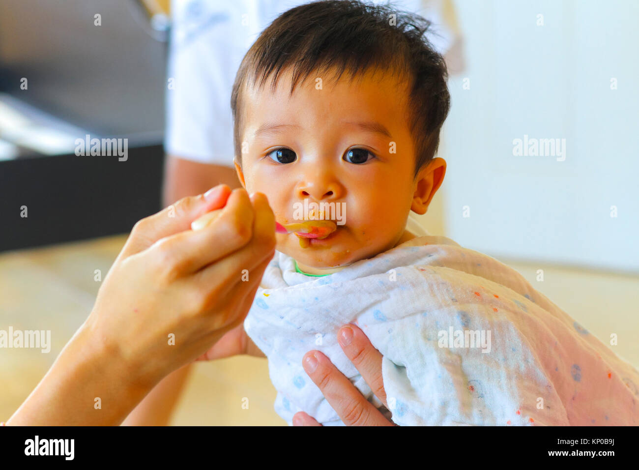 happy eating little asian boy enjoys eating food Stock Photo - Alamy