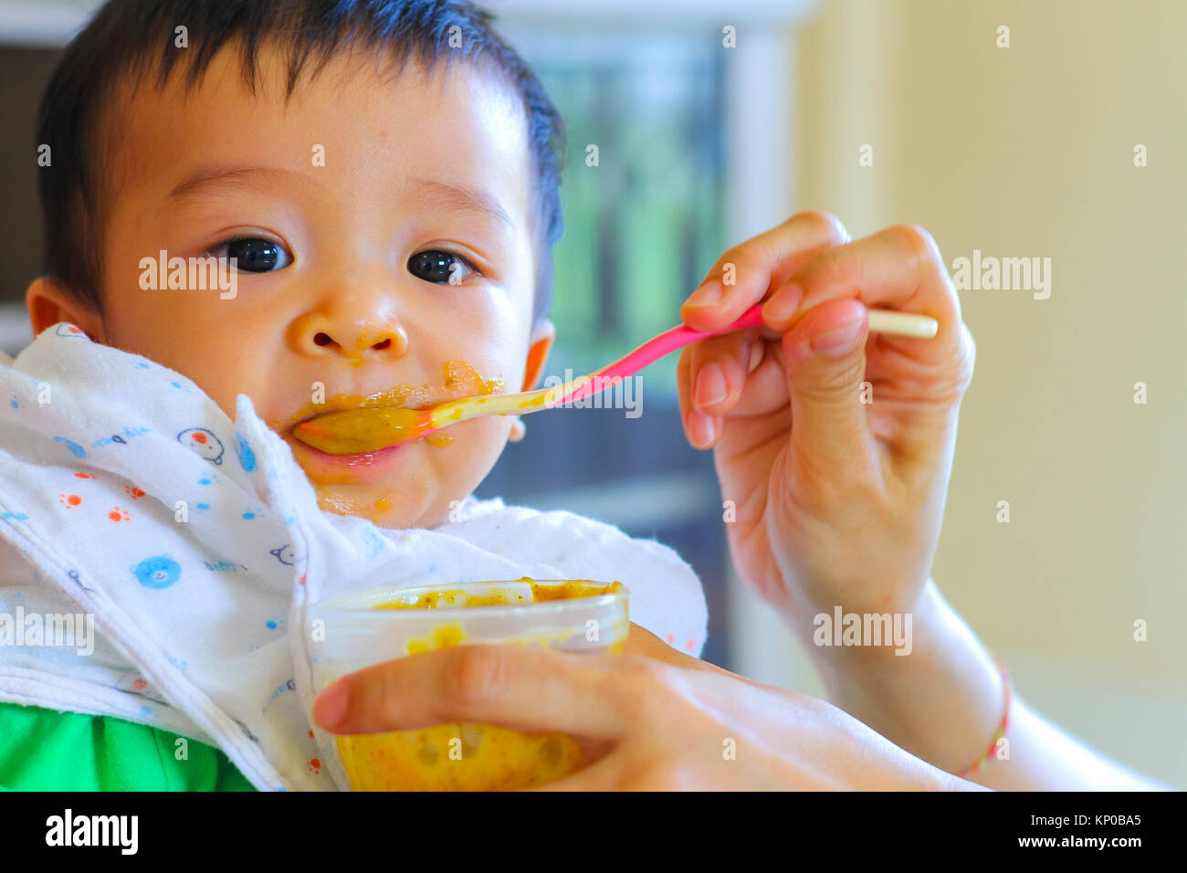 happy eating little asian boy enjoys eating food Stock Photo - Alamy