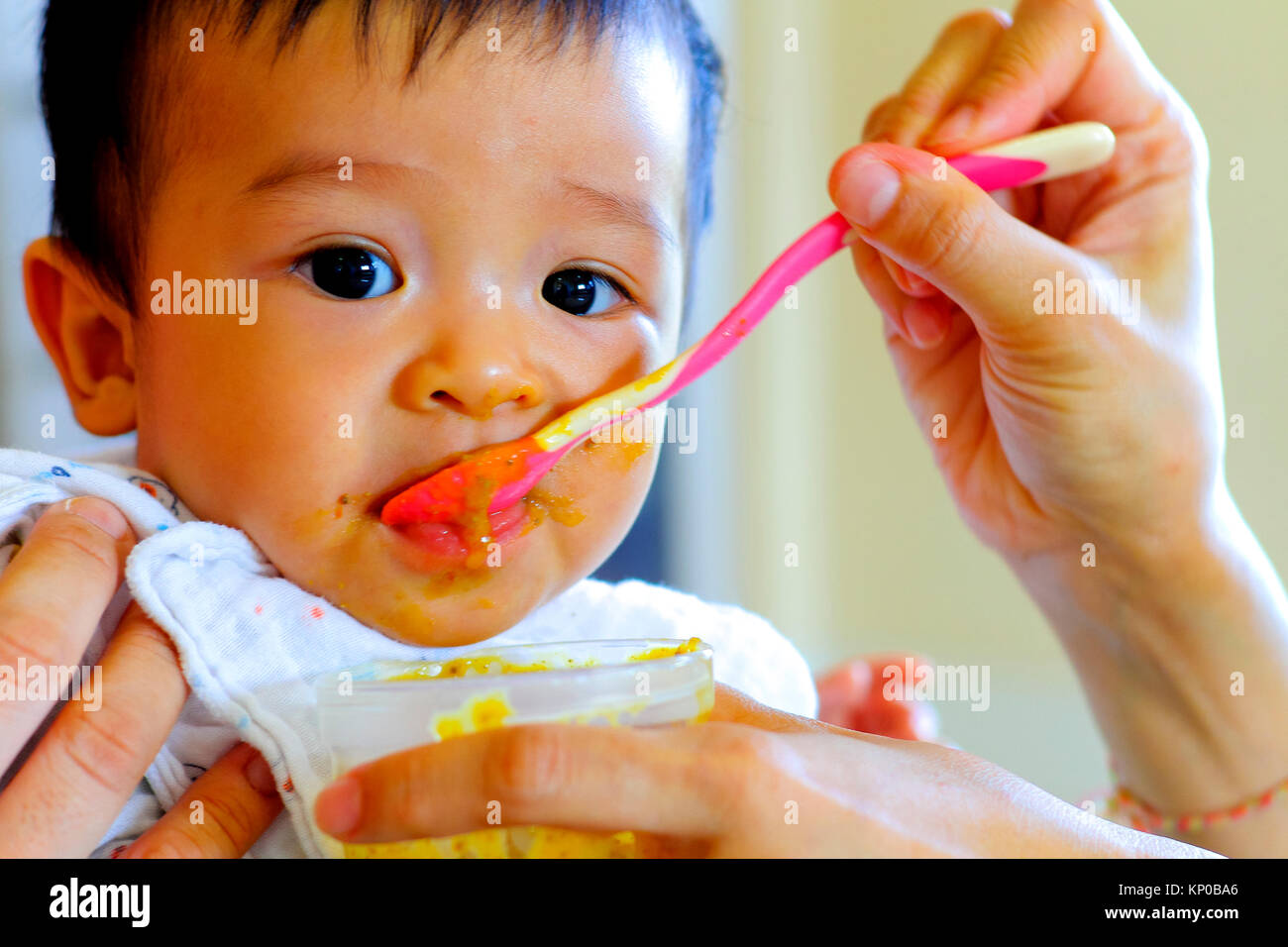 happy eating little asian boy enjoys eating food Stock Photo - Alamy