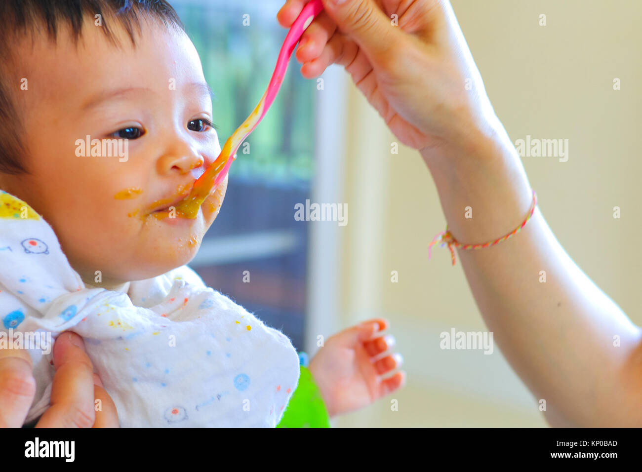 happy eating little asian boy enjoys eating food Stock Photo - Alamy