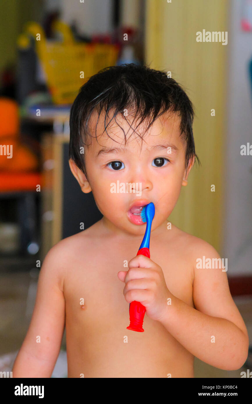 kid boy brushing teeth and smiling Stock Photo - Alamy
