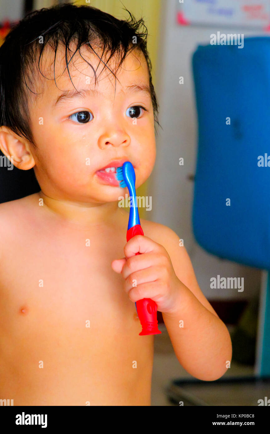 kid boy brushing teeth and smiling Stock Photo - Alamy