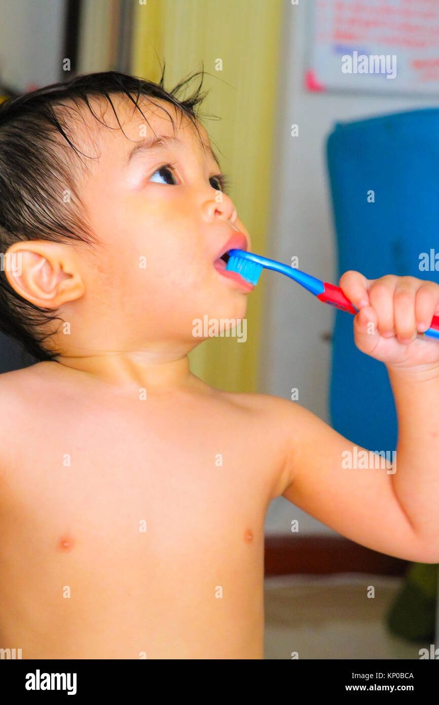 kid boy brushing teeth and smiling Stock Photo - Alamy