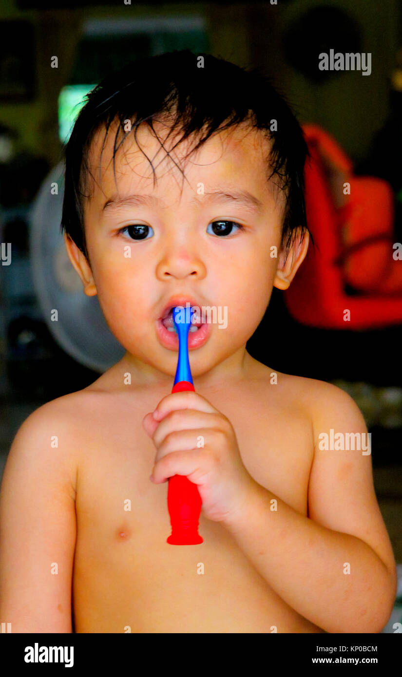 kid boy brushing teeth and smiling Stock Photo - Alamy