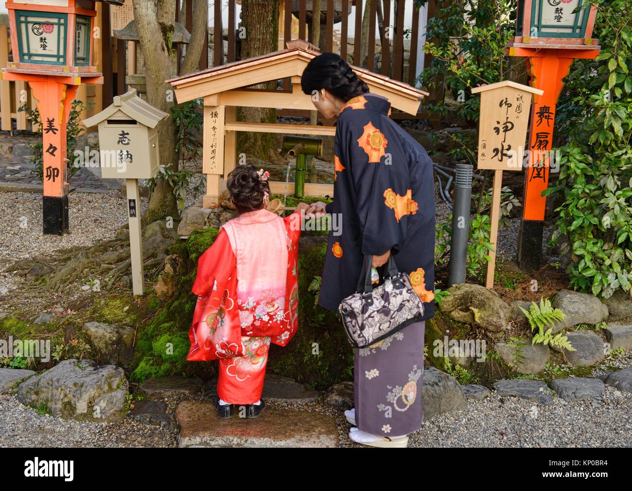 Scooping holy water at the Yasaka Shrine in Kyoto, Japan Stock Photo ...