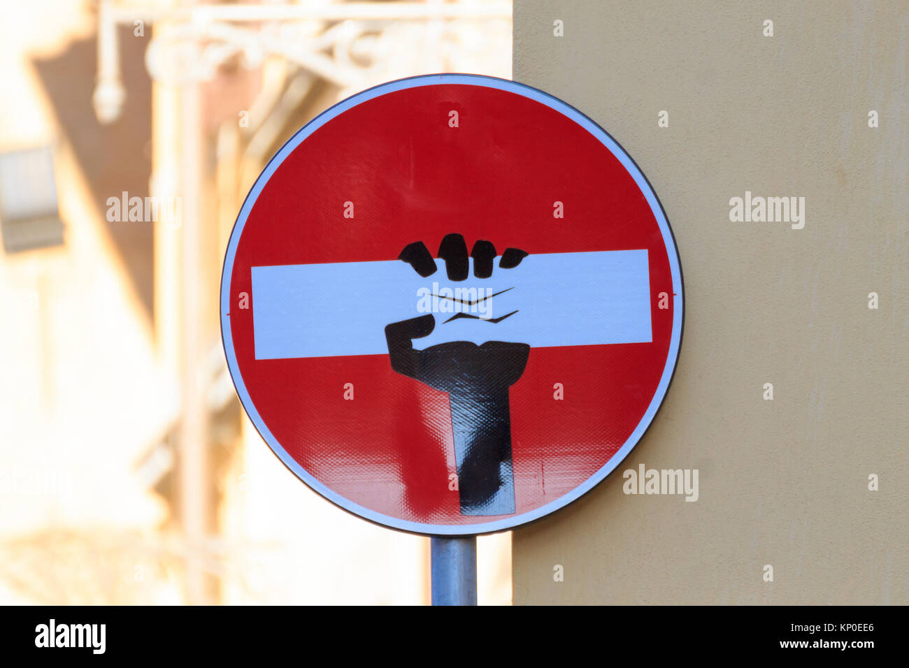 Road sign with an hand that break out the signal, street art ...