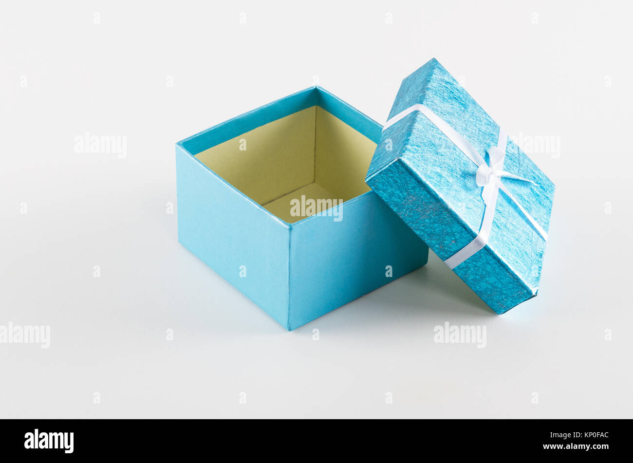 Empty blue gift box with ribbon on white Stock Photo - Alamy