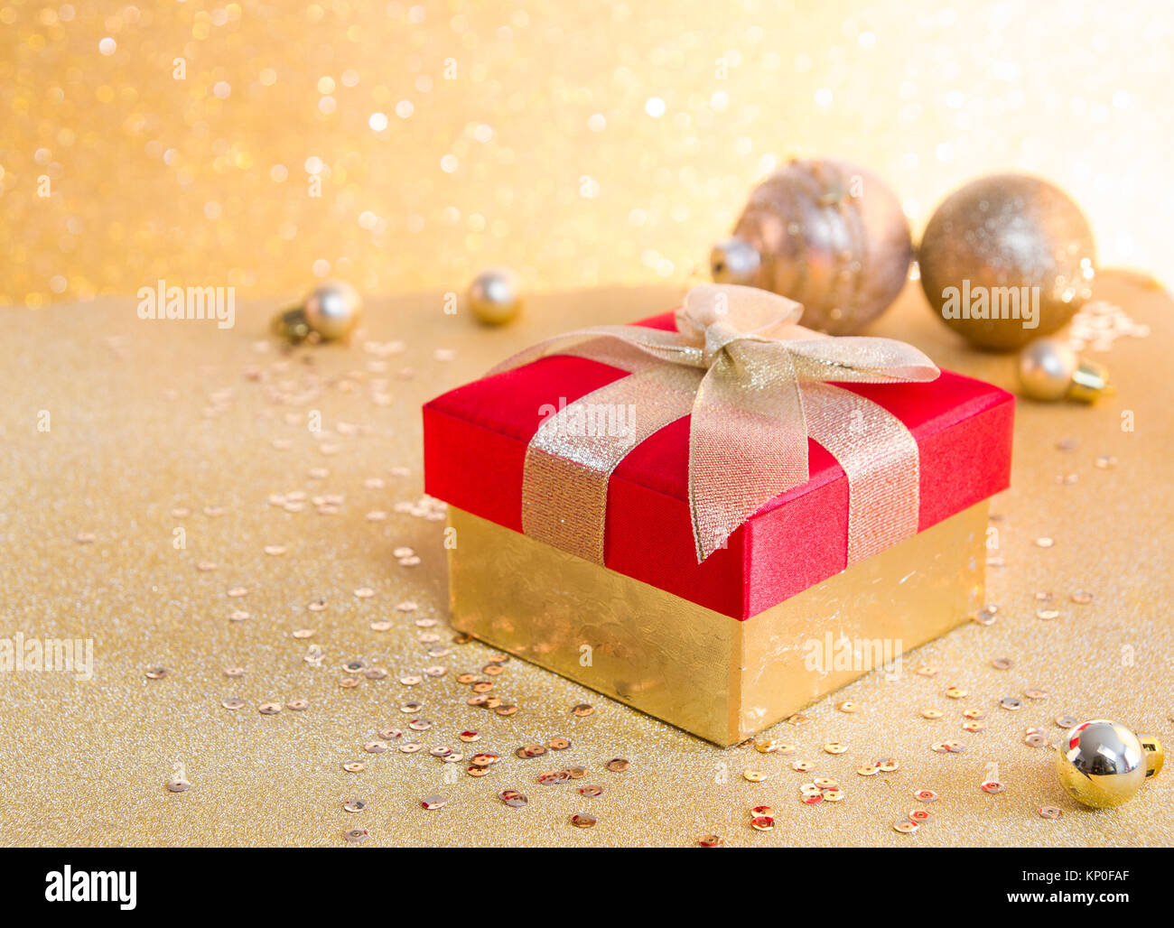 Gift box with ribbon on gold glitter background Stock Photo - Alamy