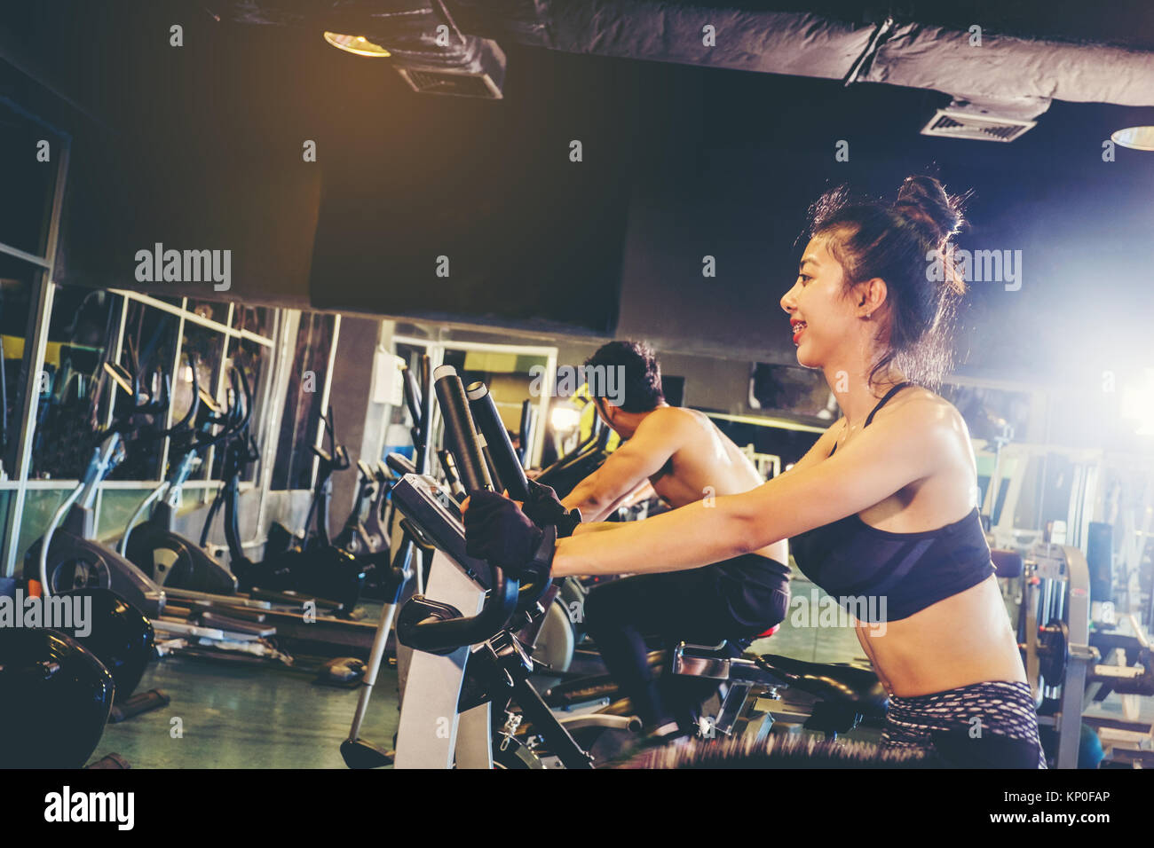 Group of people in the gym exercising legs doing cardio training Stock ...