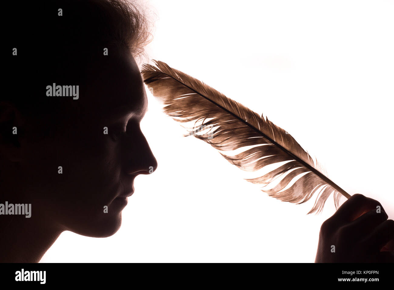 silhouette of a person in profile with quill near bow on a white ...