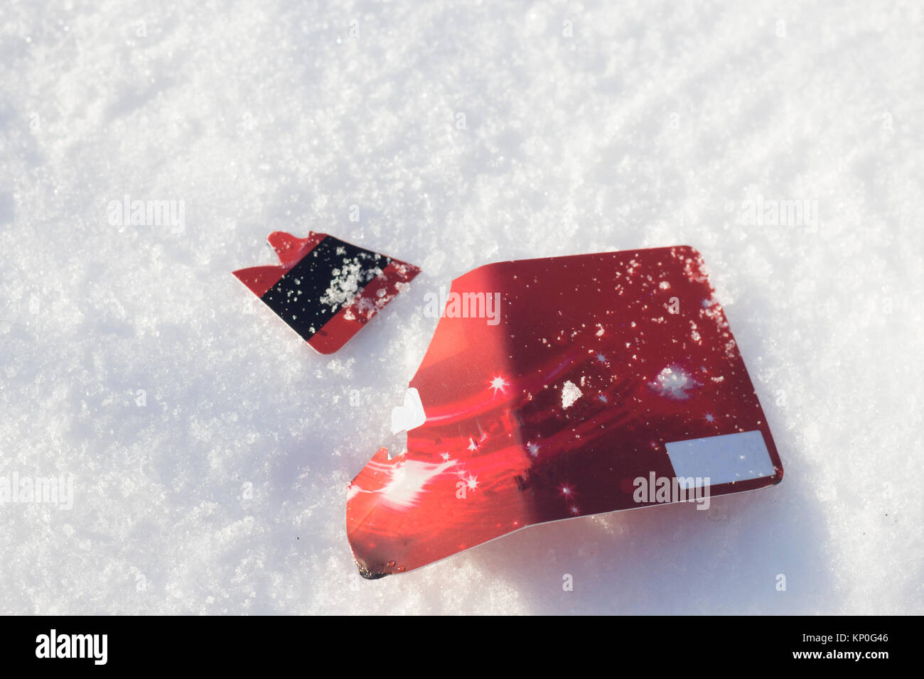 Red broken credit card lies on snow with footprint background Stock ...