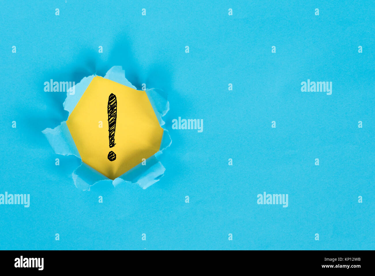 blue torn paper revealing exclamation mark on yellow paper. exclamation ...