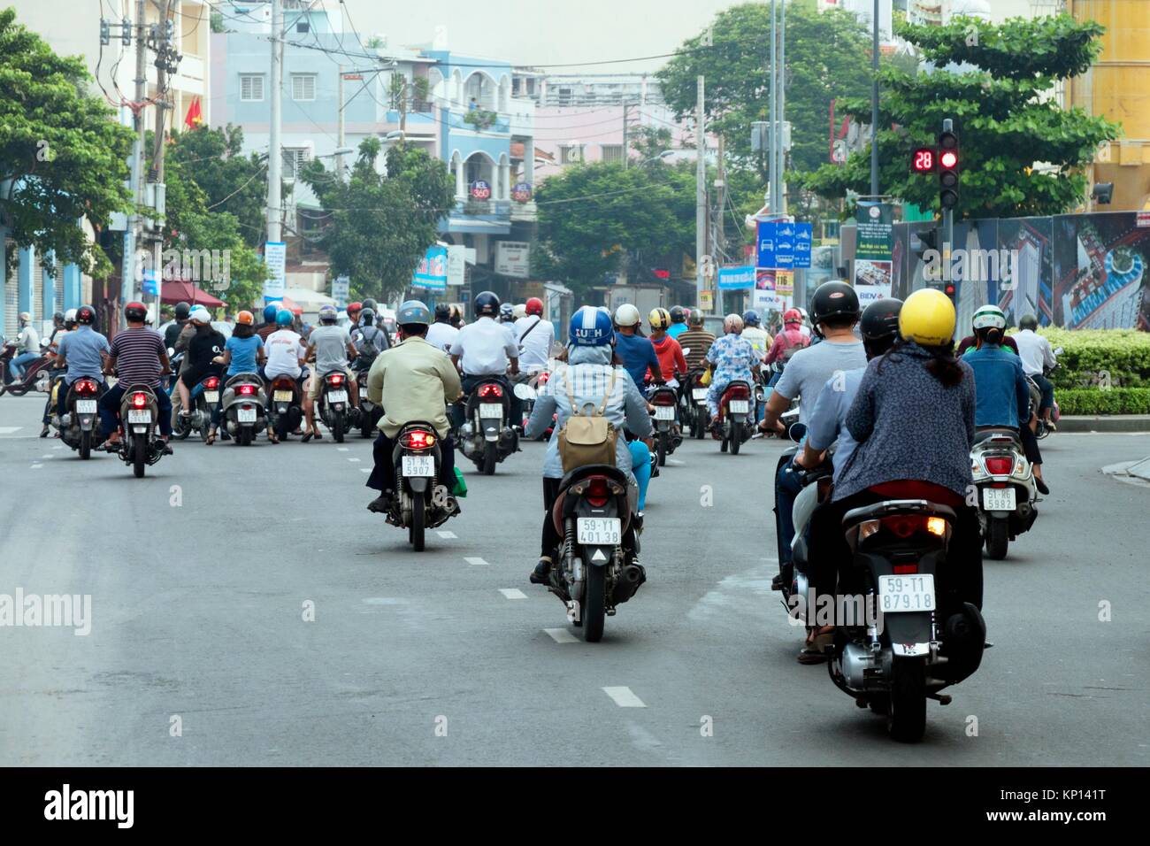 Street setting, moped riders on a street at Saigon, Hoh Chi Minh City ...
