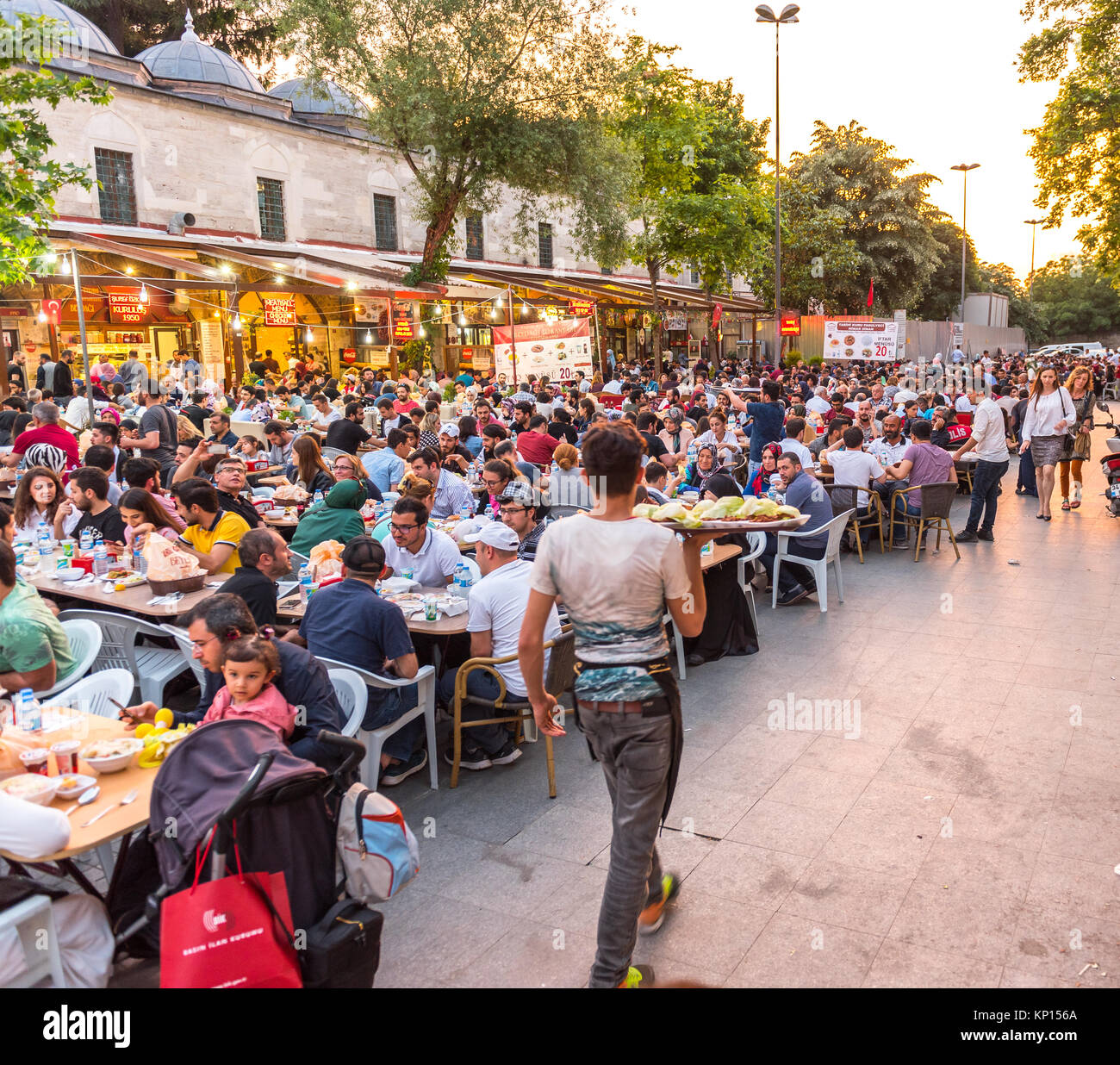 Muslim people who are fasting wait for adhan (ezan) and evening meal ...