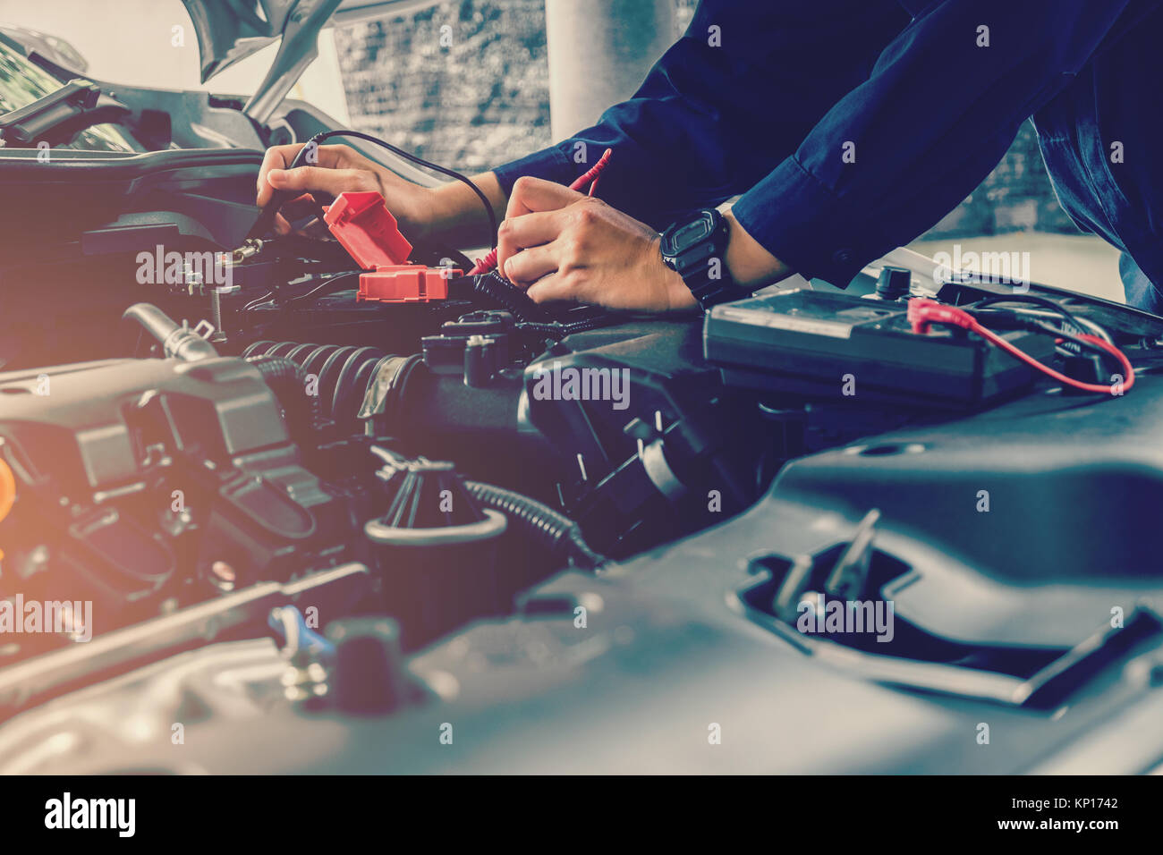 Auto mechanic checking car battery voltage Stock Photo - Alamy