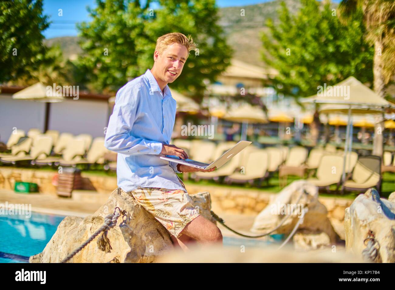 young business man with laptop computer in holiday destination Stock ...