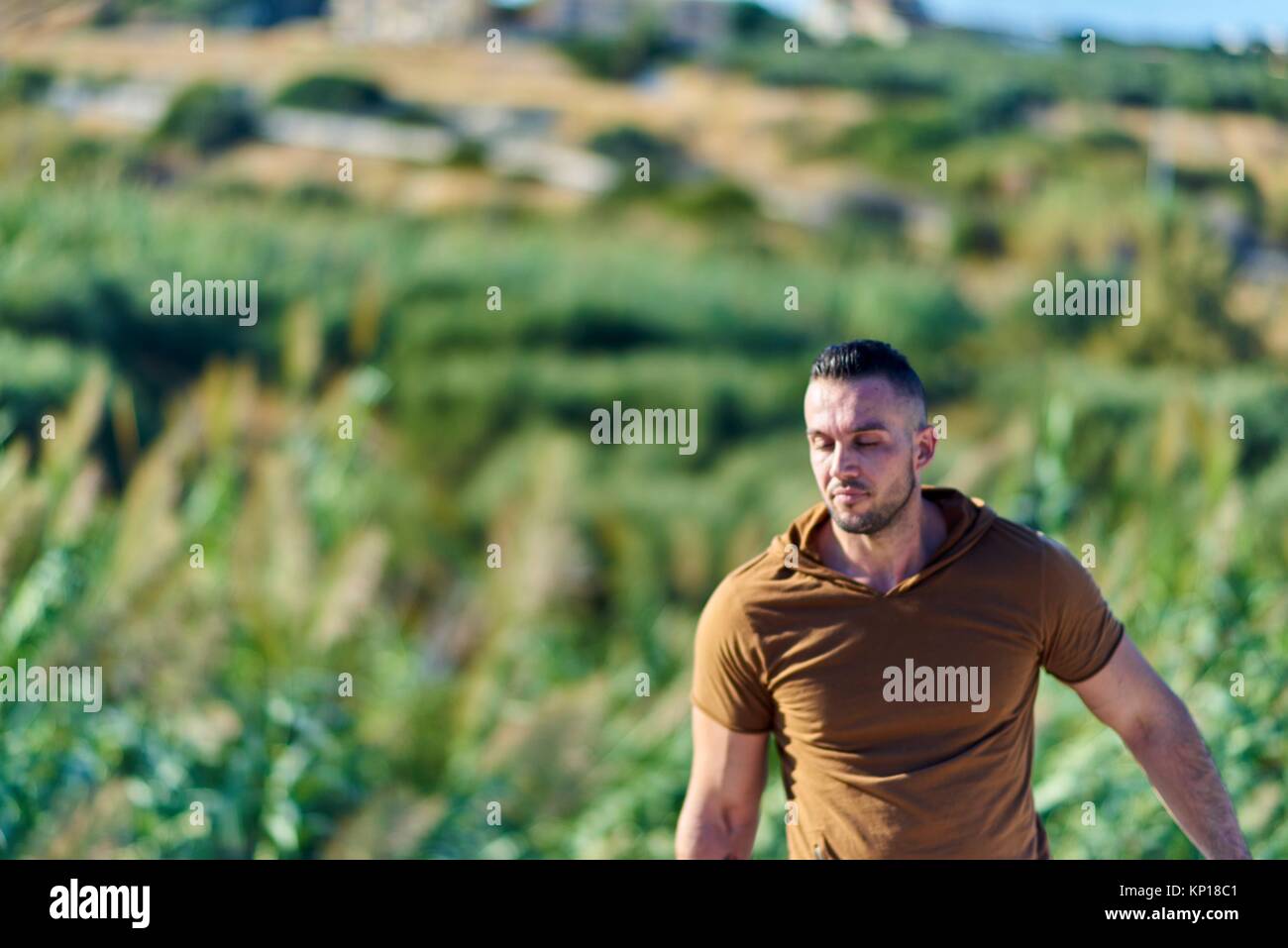 man with closed eyes enjoying nature. Half Greek and half English ...