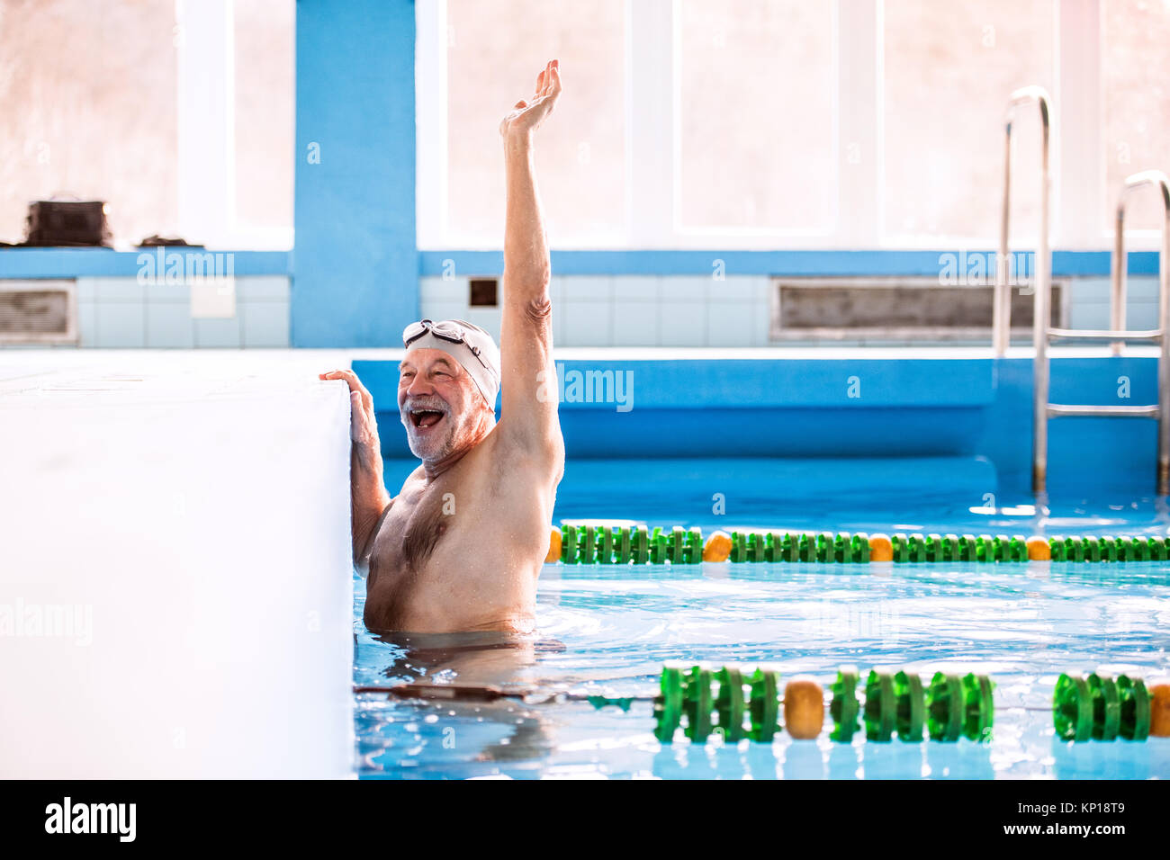 Senior man swimming in an indoor swimming pool Stock Photo - Alamy