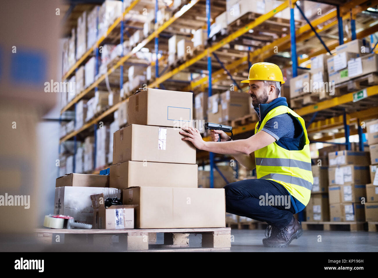 Male warehouse worker with barcode scanner Stock Photo - Alamy