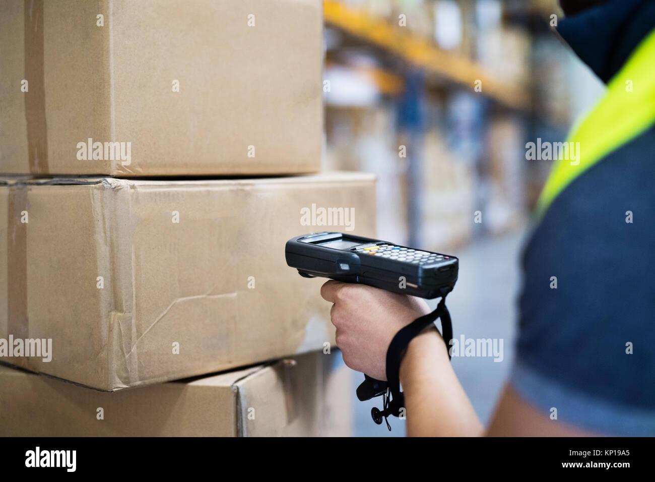 Male warehouse worker with barcode scanner Stock Photo - Alamy
