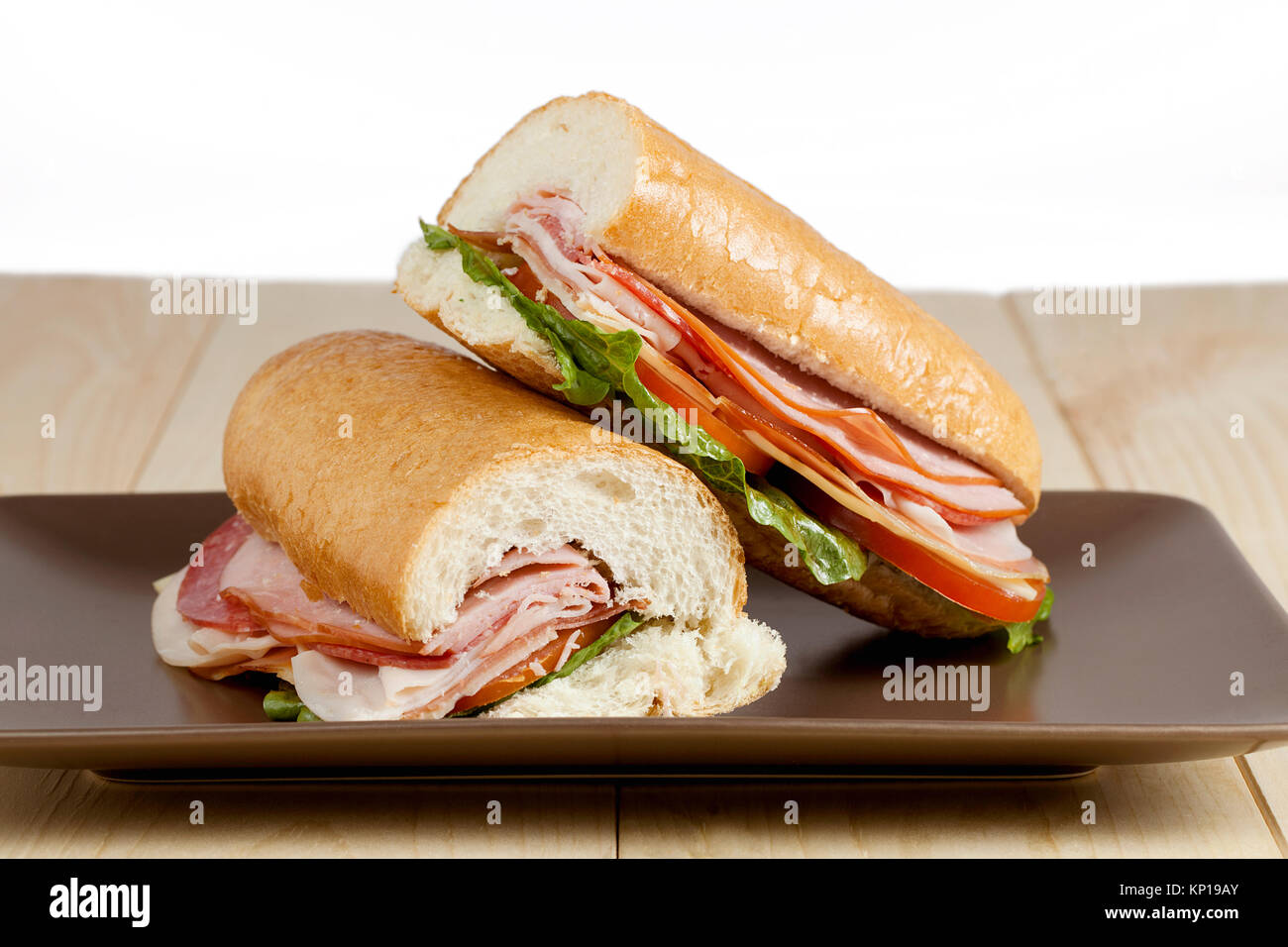 slices of ham sandwich on brown plate Stock Photo - Alamy