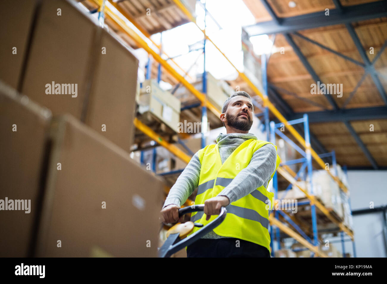 Warehouse pulling pallet truck boxes hi-res stock photography and ...