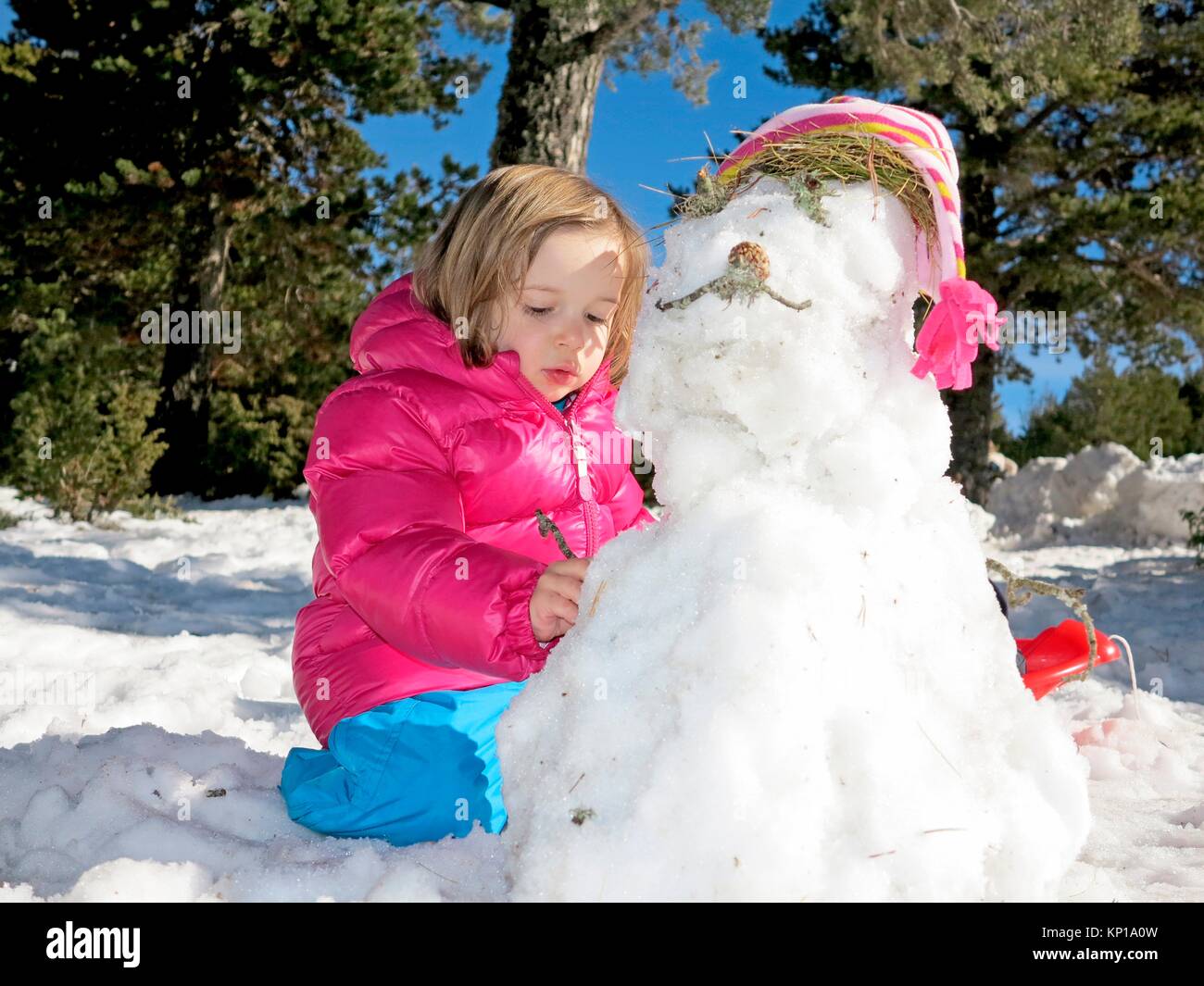 Girl making a snowman hi-res stock photography and images - Alamy