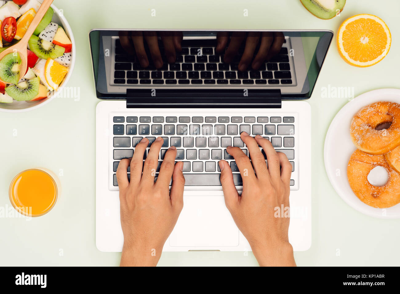 Healthy business lunch in office, fruit salad bowl near laptop on white ...
