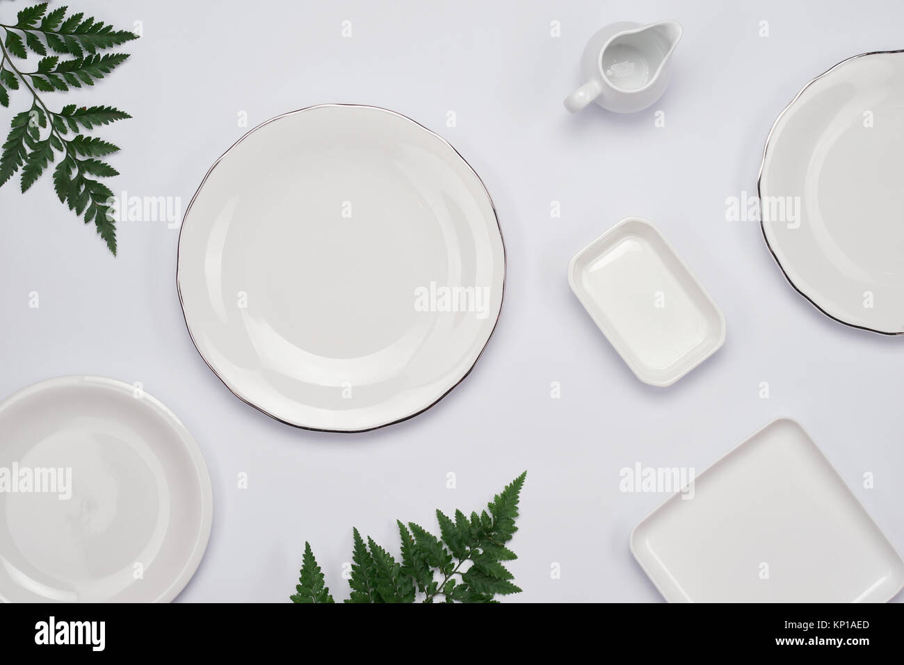 Ceramic plates on white background. Top view Stock Photo - Alamy