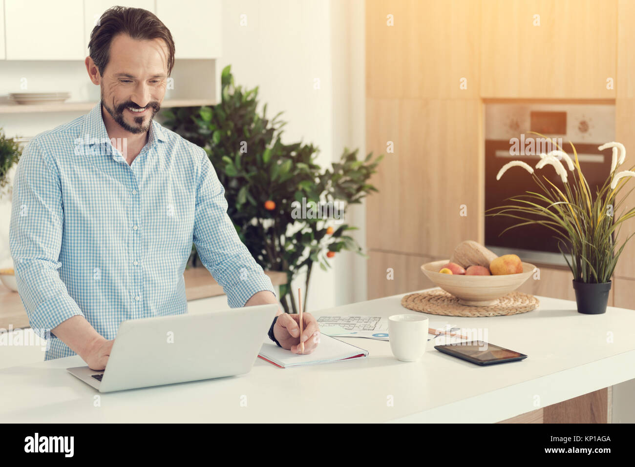 Delighted happy man taking notes Stock Photo - Alamy