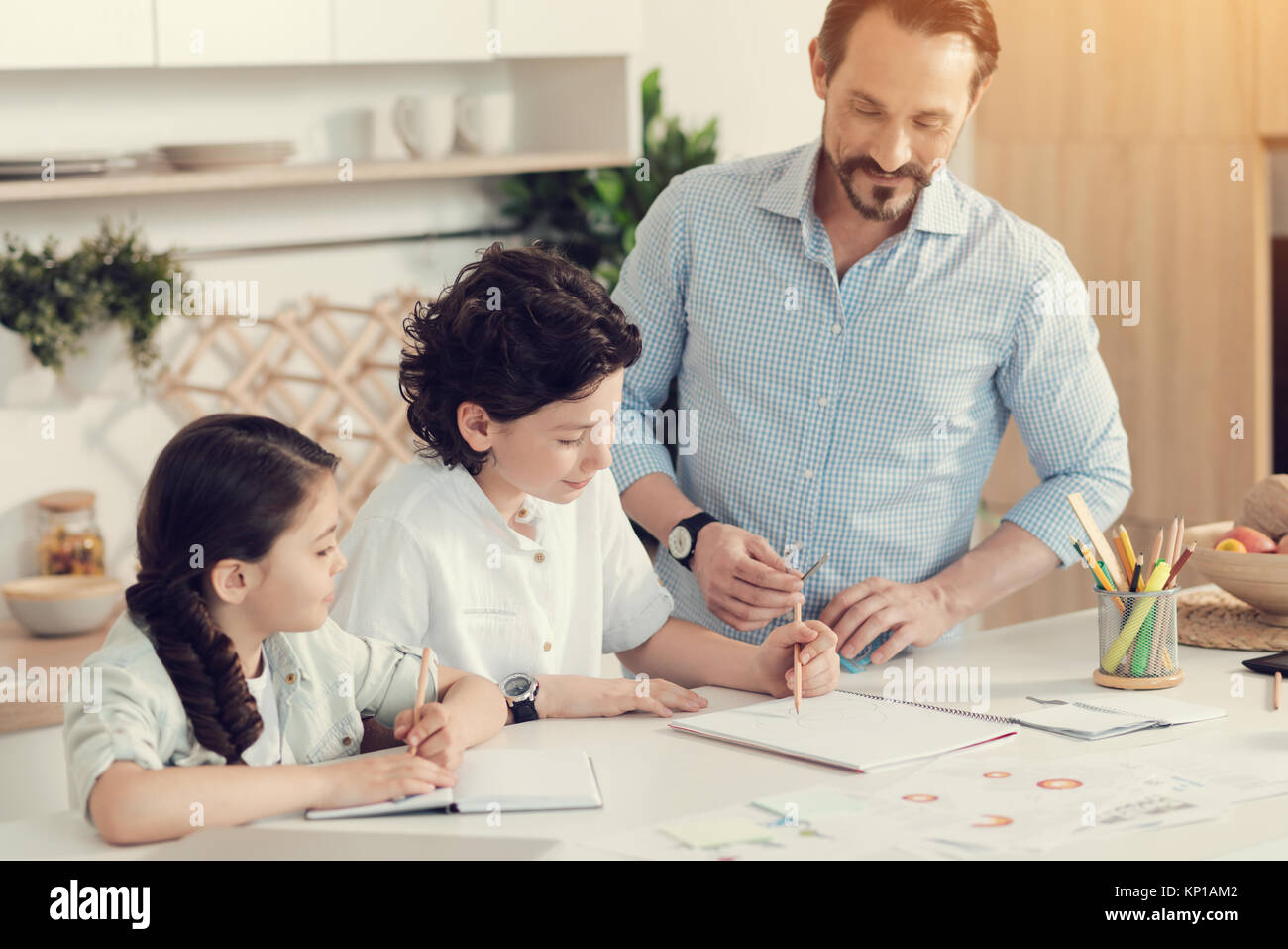 Delighted nice boy holding a pencil Stock Photo - Alamy