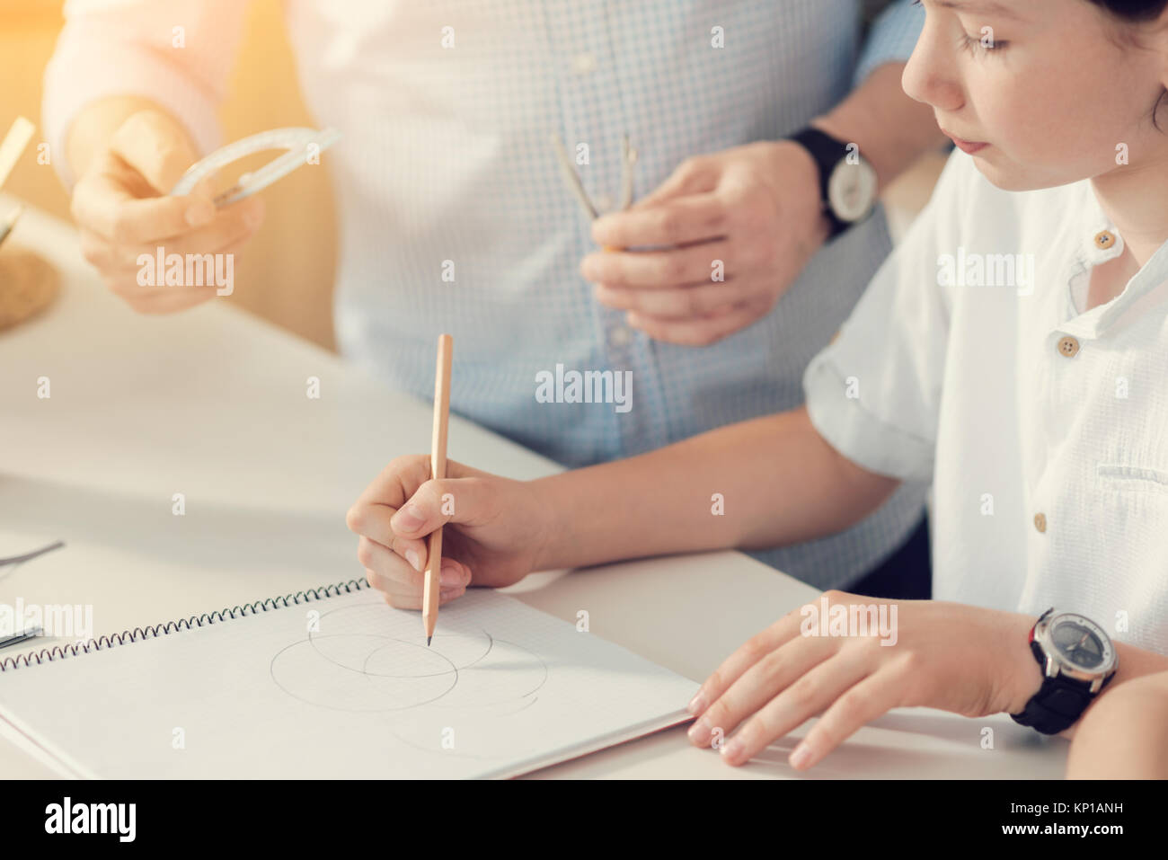 Pleasant smart boy drawing circles Stock Photo - Alamy