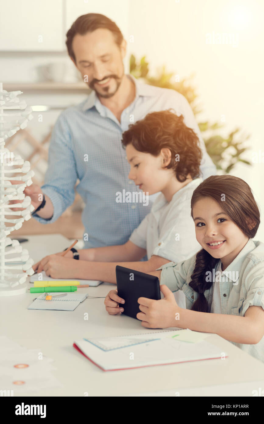 Joyful pretty girl sitting at the table Stock Photo - Alamy