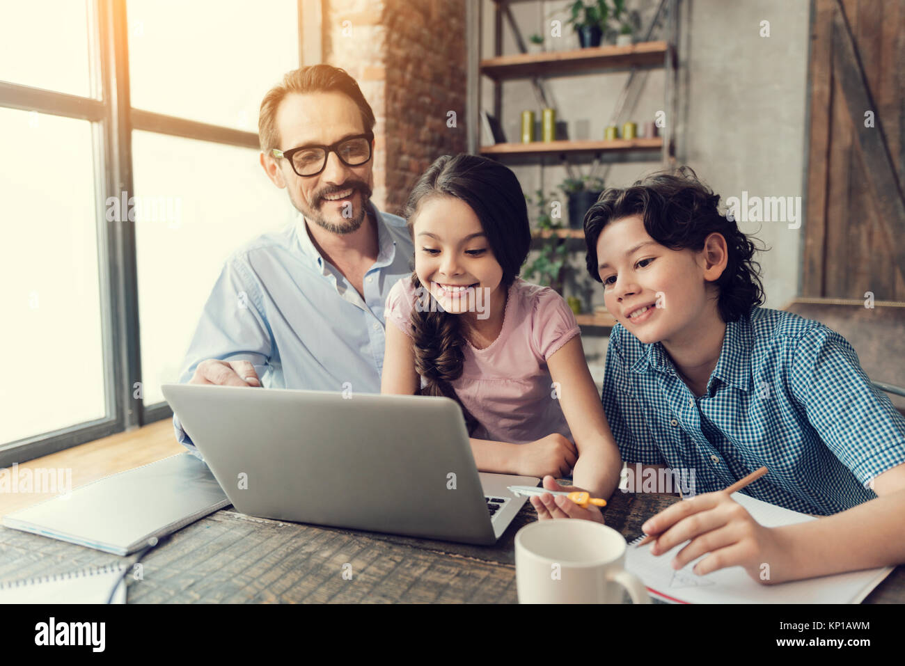 Delighted smart children working on the laptop Stock Photo - Alamy
