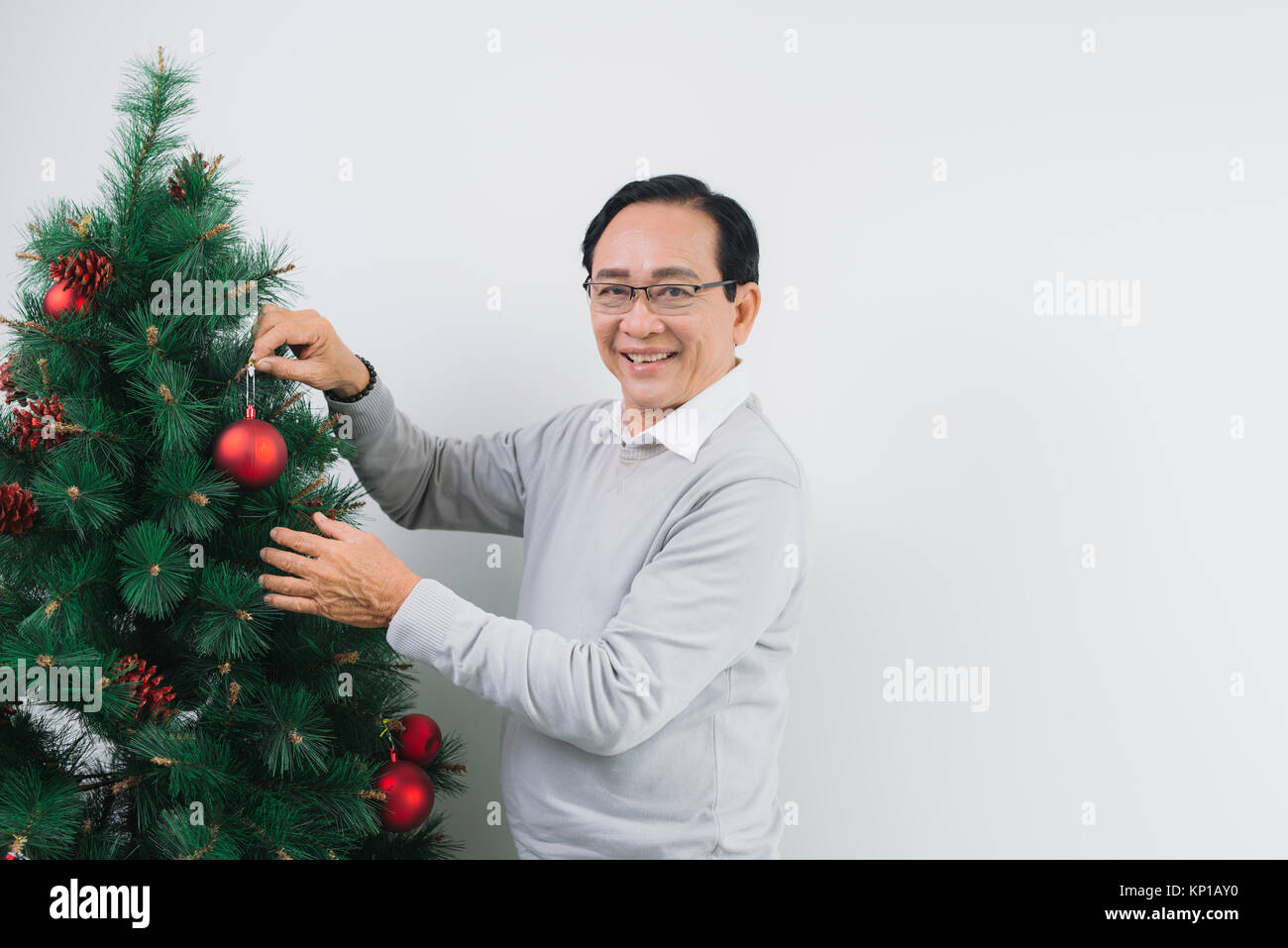 Asian family decorating christmas tree hi-res stock photography and ...