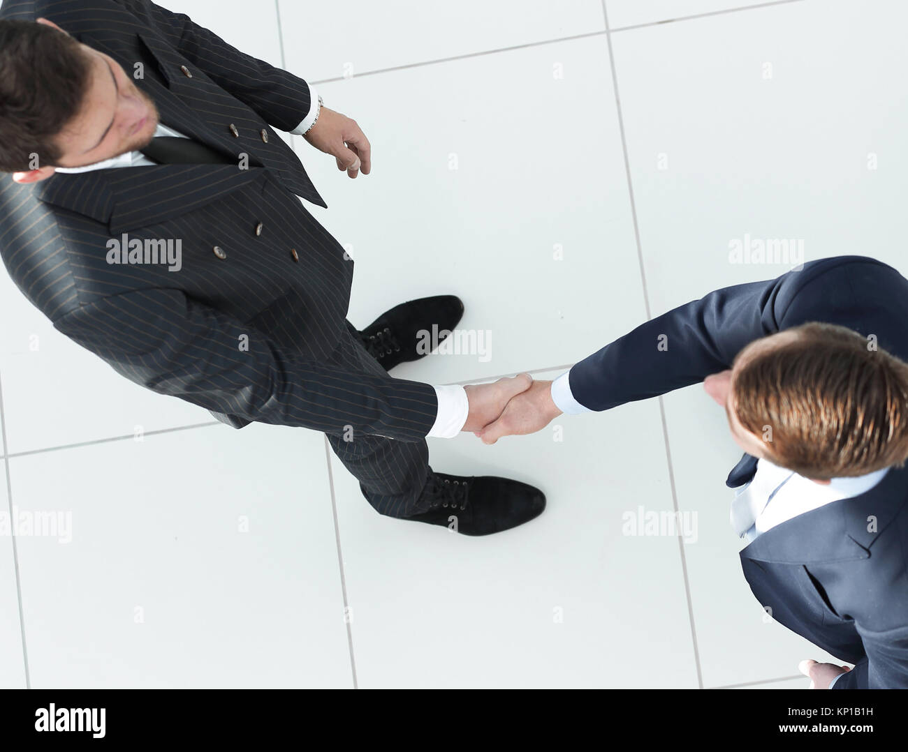 view from the top.handshake, business partners ,isolated on white ...