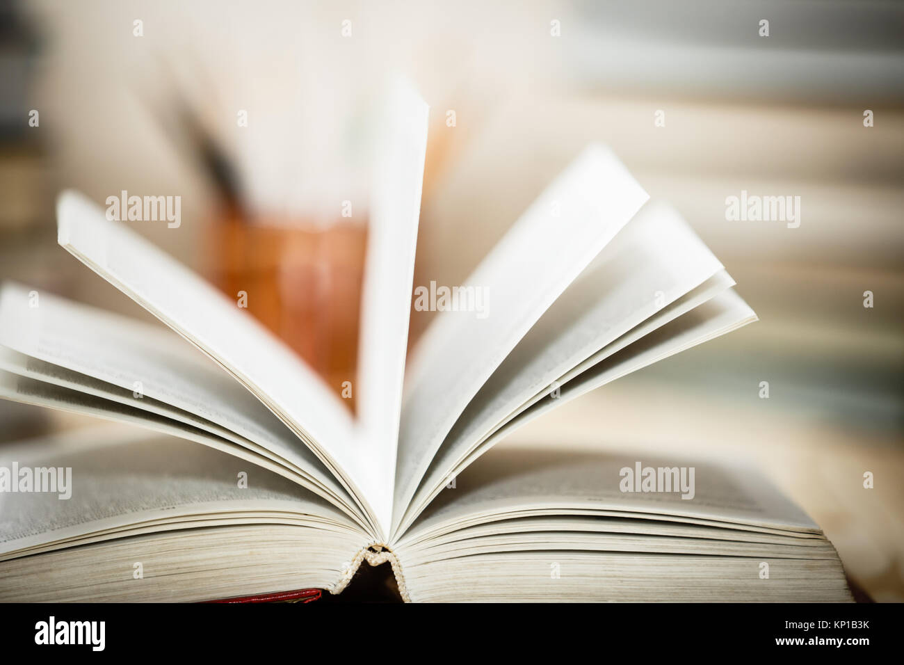 Open textbooks on wood desk with blurred focus for education background ...