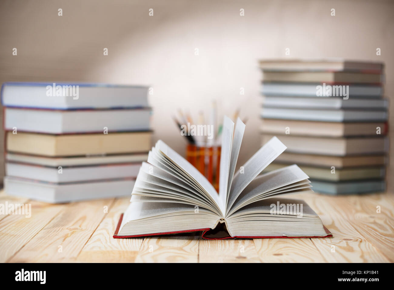 Open textbooks on wood desk with blurred focus for education background ...