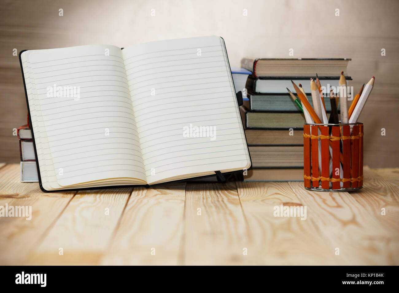 Open textbooks on wood desk with blurred focus for education background ...