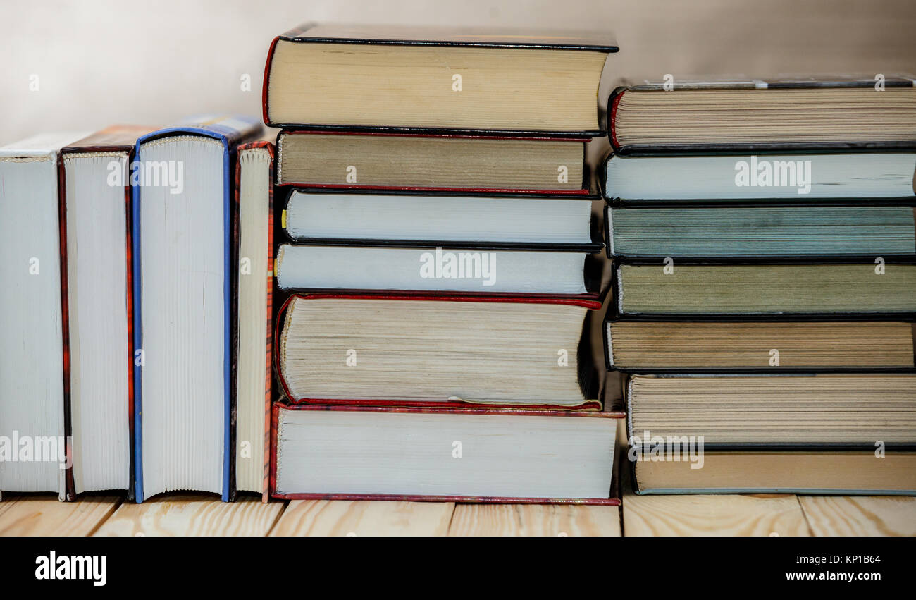 Textbooks and books on a wooden table. Book stack in the library room ...