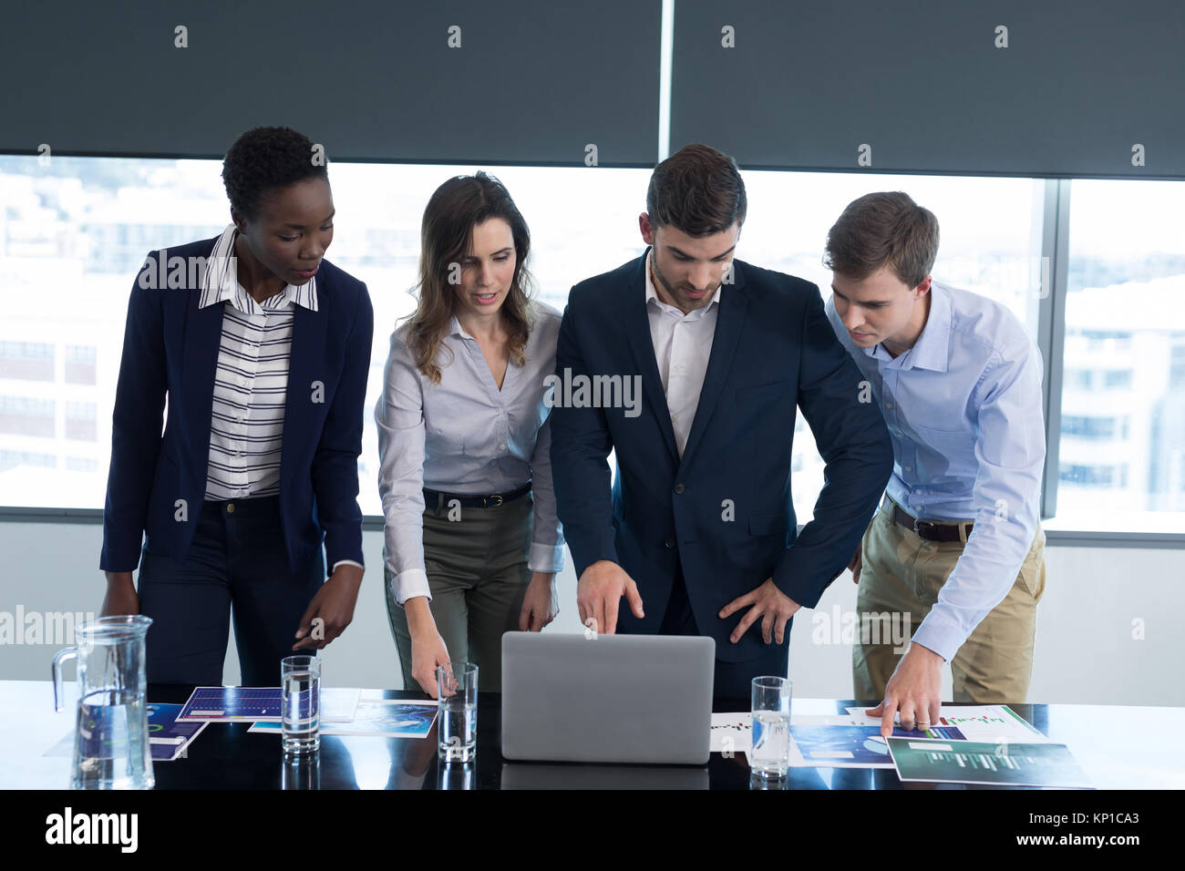 Executives working together at desk in office Stock Photo - Alamy
