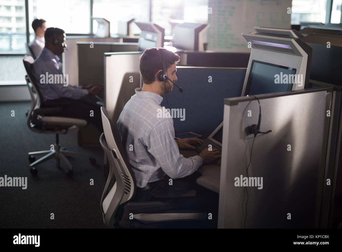 Attentive customer service executives working at office Stock Photo - Alamy