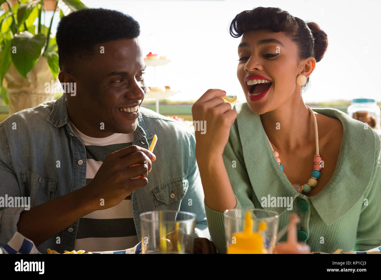 Happy couple having food in the restaurant Stock Photo - Alamy