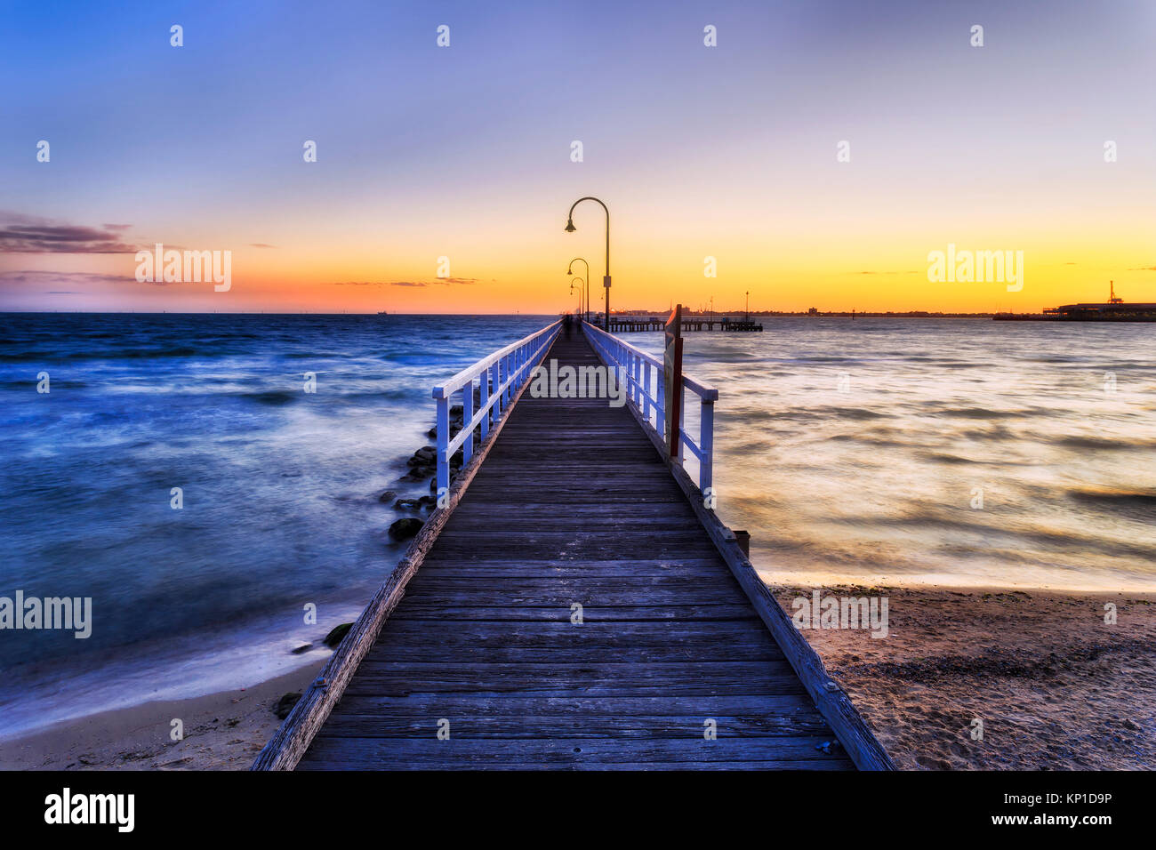 Historic timber long jetty off Port Melbourne beach on Port Phillip bay ...