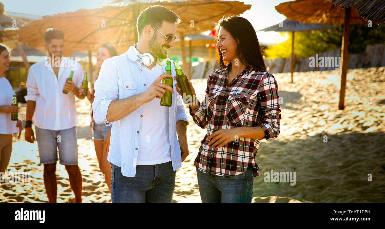 Friends partying and having fun on beach at summer Stock Photo - Alamy