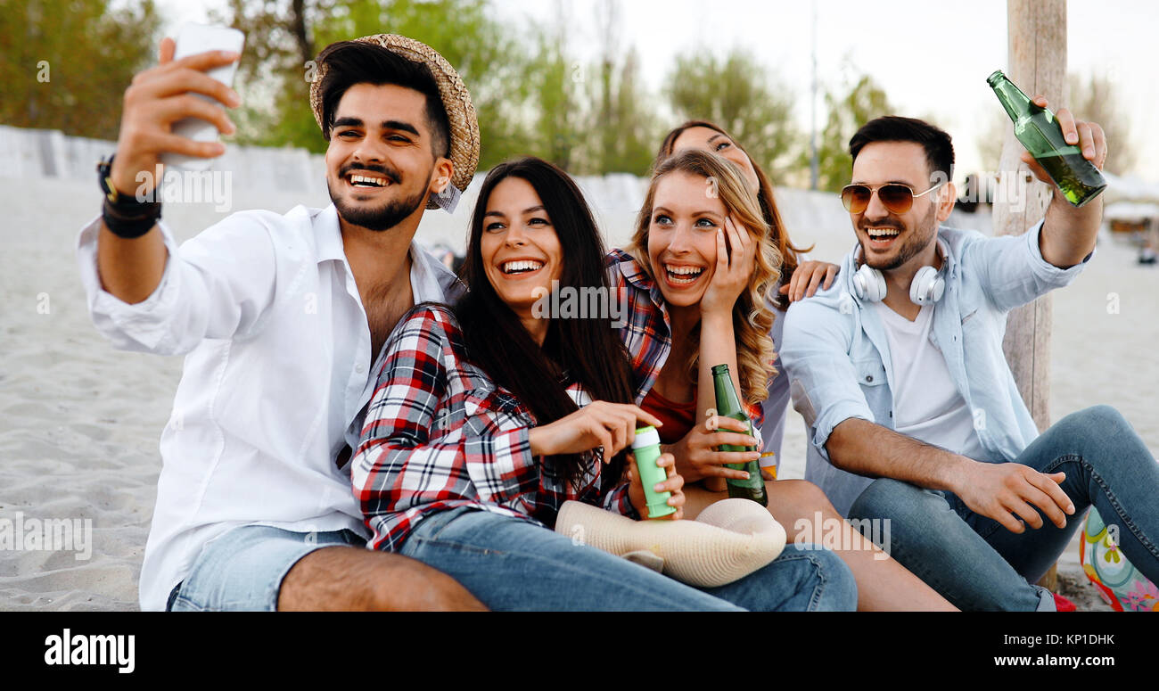 Friends partying and having fun on beach at summer Stock Photo - Alamy