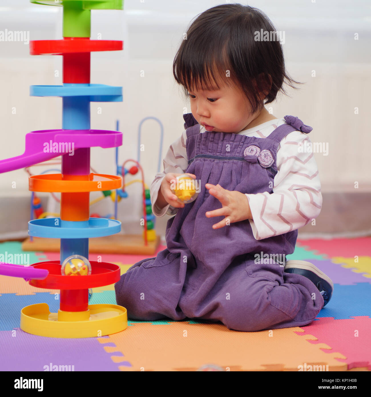 Baby girl play toy at home Stock Photo - Alamy