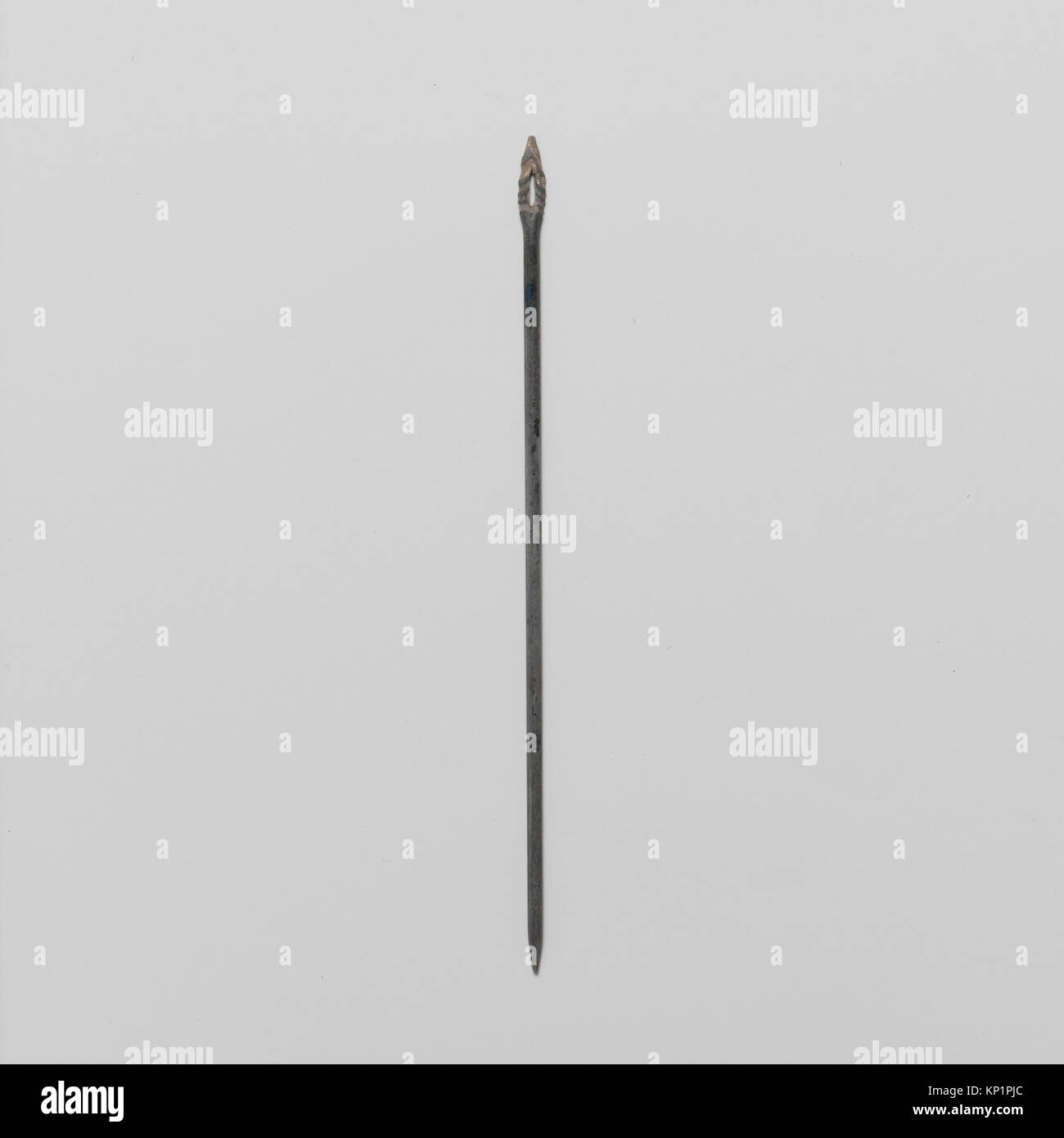A slender MET glass needle, illustrating the detailed work and artistry ...