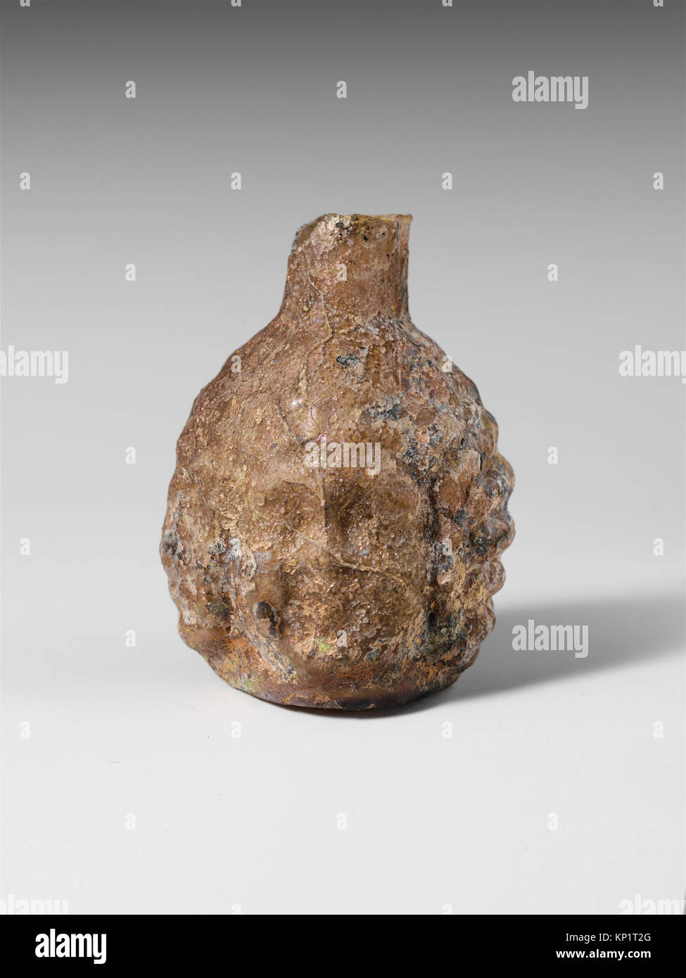 A head-shaped glass flask with a hollow interior, created for storage ...