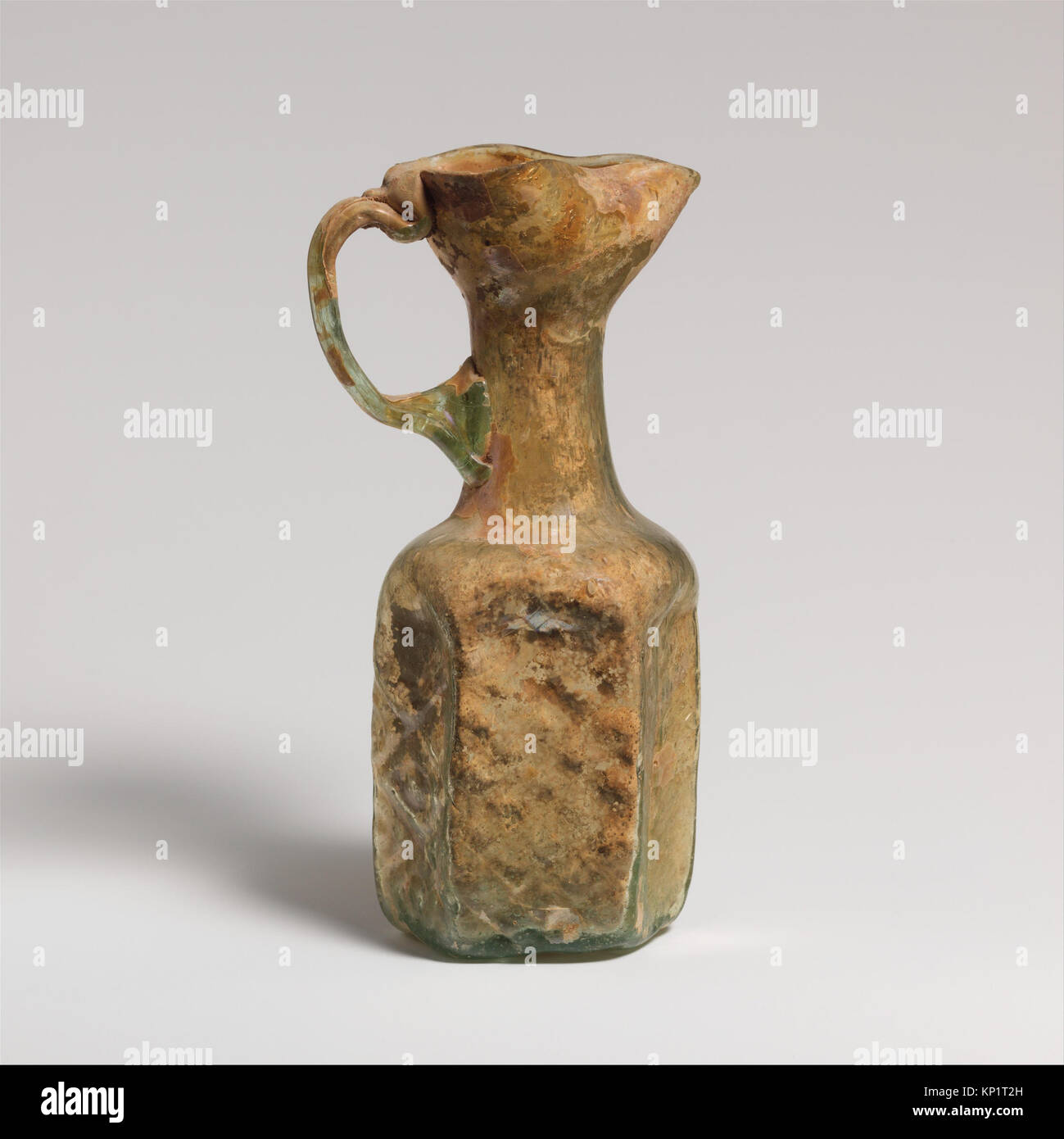A six-sided glass jug featuring a hexagonal design, used for storing ...